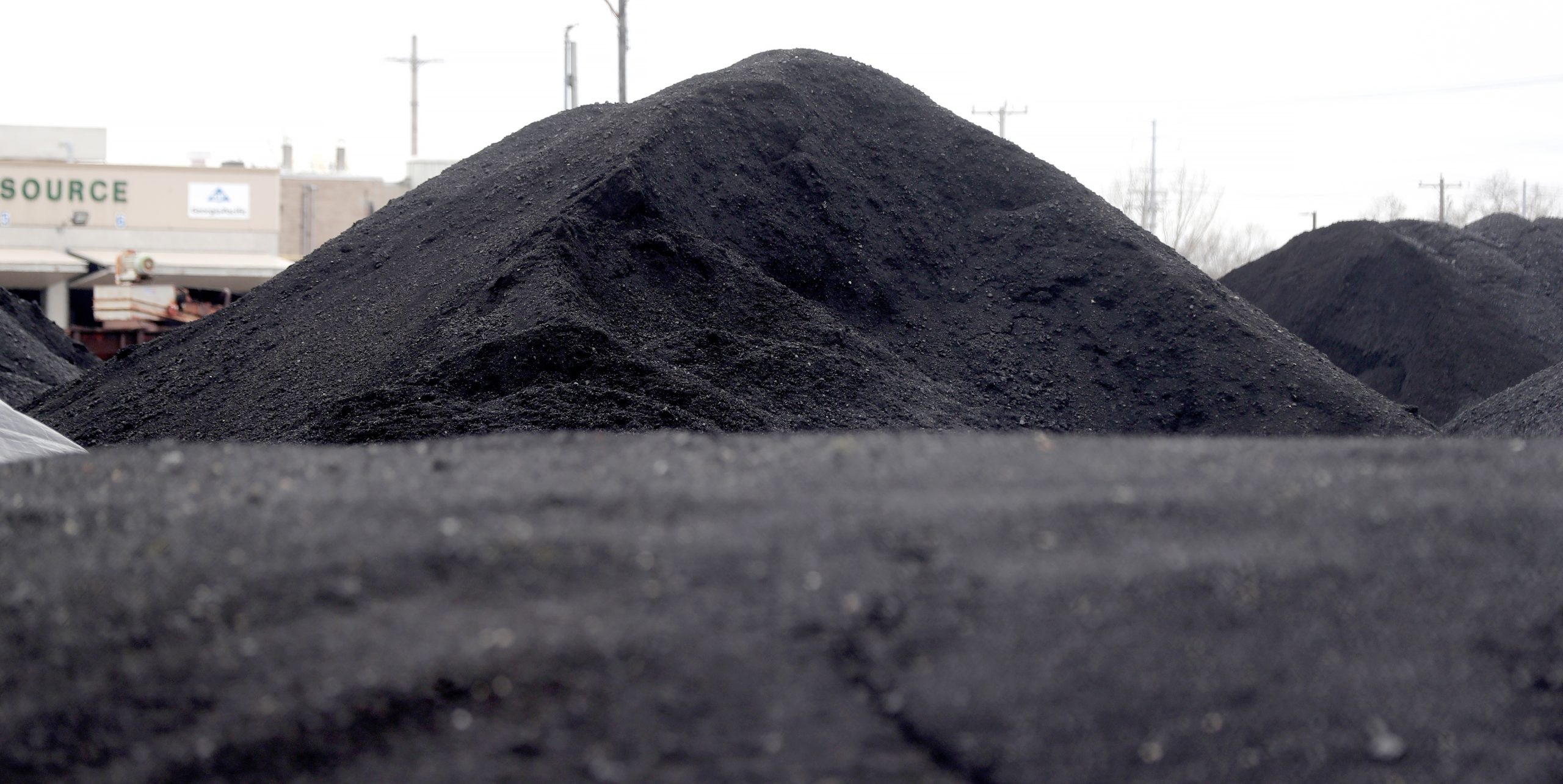 What are the health risks of coal piles like the ones in Green Bay?